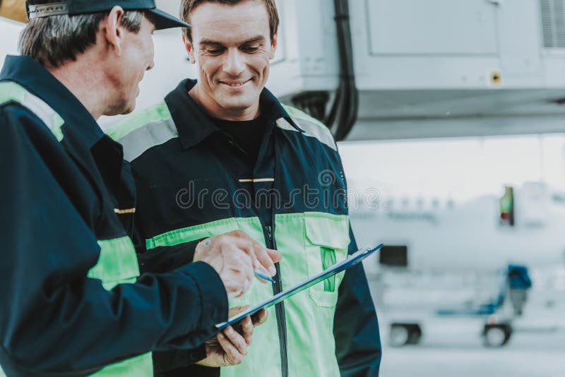 Experienced Man Explaining Something To Young Colleague Stock Photo ...