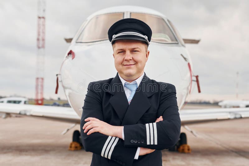 Experienced Pilot in Uniform Standing Outside Near Plane Stock Photo ...