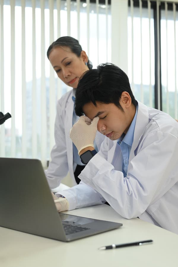 Experienced Scientists Team Conducting Experiments in Laboratory ...