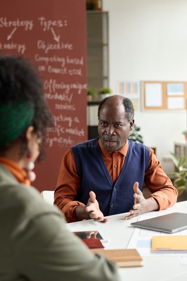Experienced Senior Professor Talking To Student in Class Stock Photo ...