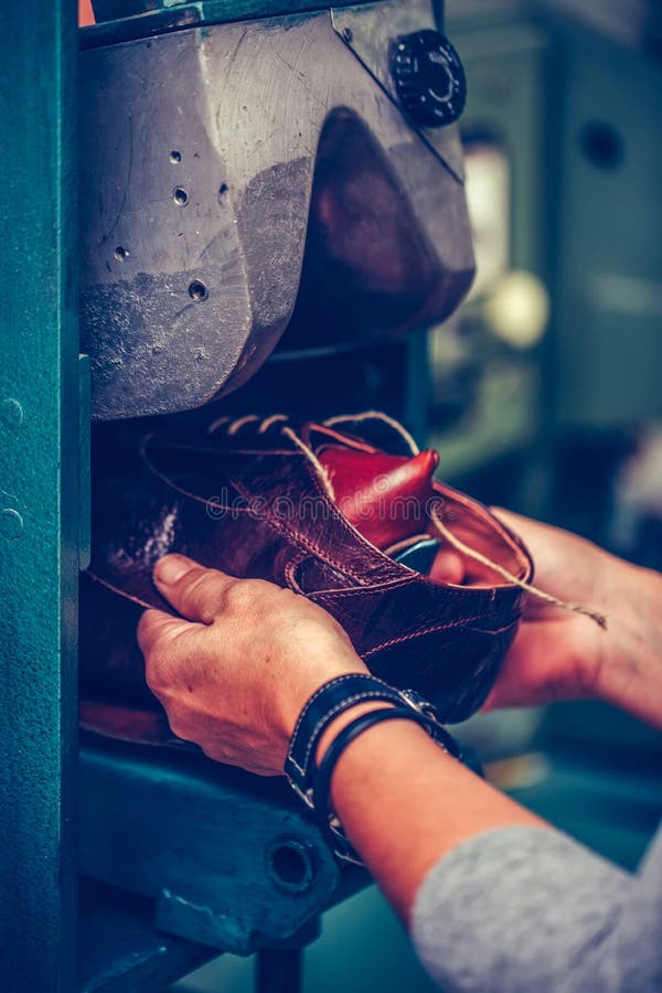Experienced Shoemaker Using a Special Machine for Putting Shoes on the ...