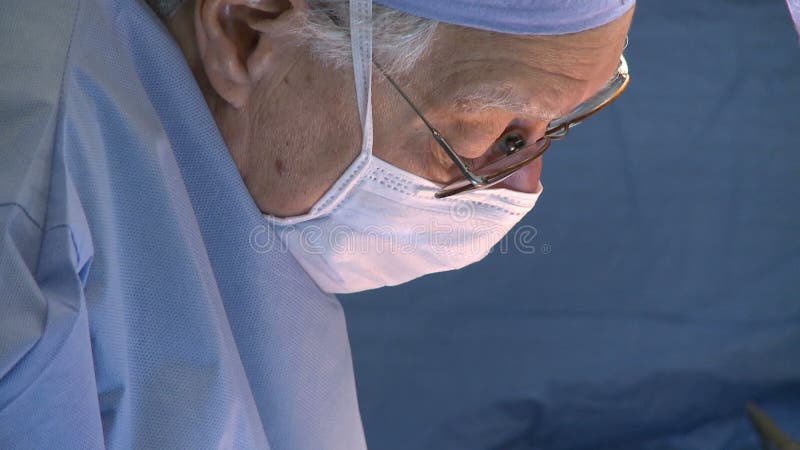 Surgeon Performing Intricate Procedure in Operating Room with Advanced ...