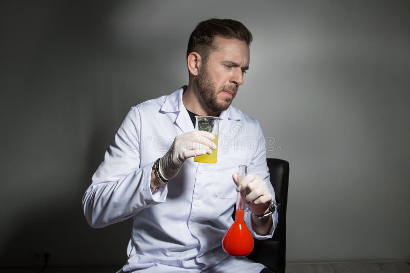 An Experienced Technician Sniffs a Chemical Reagent Medical Bulb Stock ...