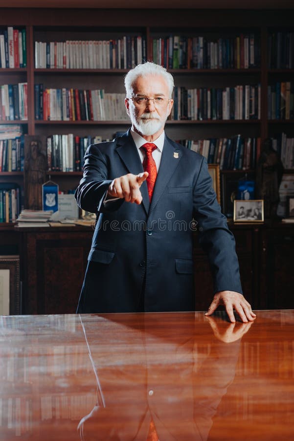 Experienced University Rector Posing Confidently among Bookshelves with ...