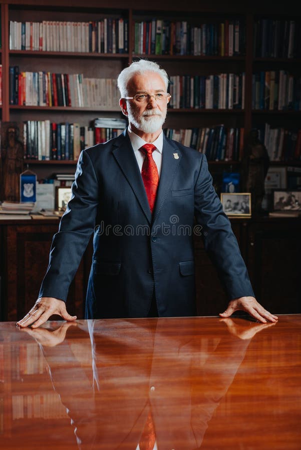 Experienced University Rector Posing Confidently in Library Setting ...