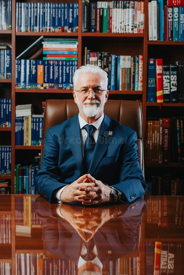 Experienced University Rector Posing in Library with Books and ...