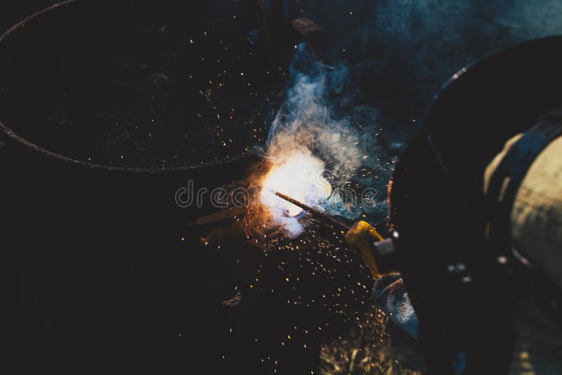 An Experienced Welder at Work. Preparation and Welding Process of Cast ...
