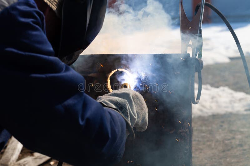 An Experienced Welder at Work. Preparation and Welding Process of Cast ...