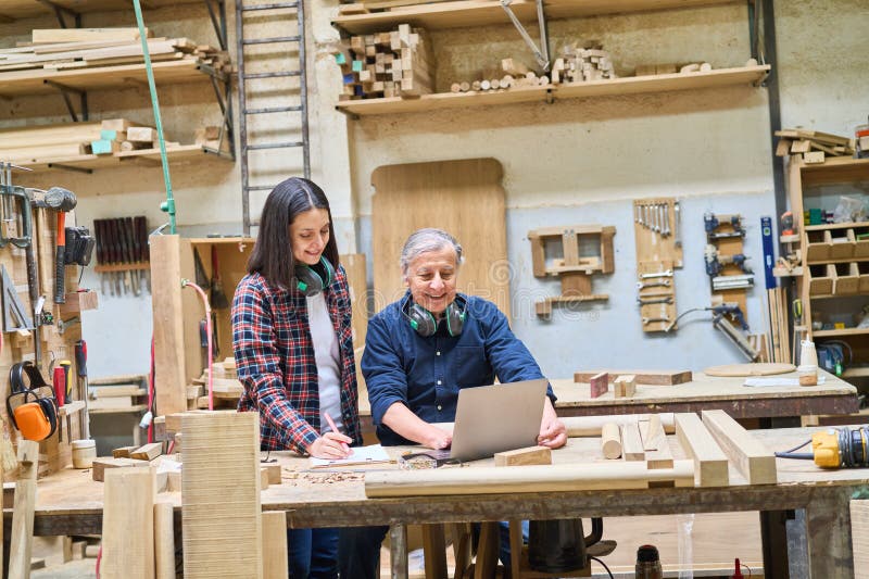 Experienced Woodworker Guiding Apprentice in a Busy Lumberyard Workshop ...