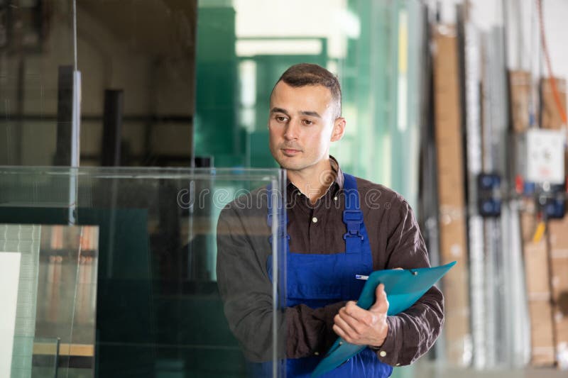 Experienced Worker Checks the Quality of Made Window Glass in an ...