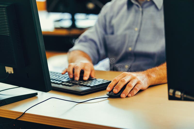Experienced Worker Intently Uses Office Computer Setup Stock Photo ...