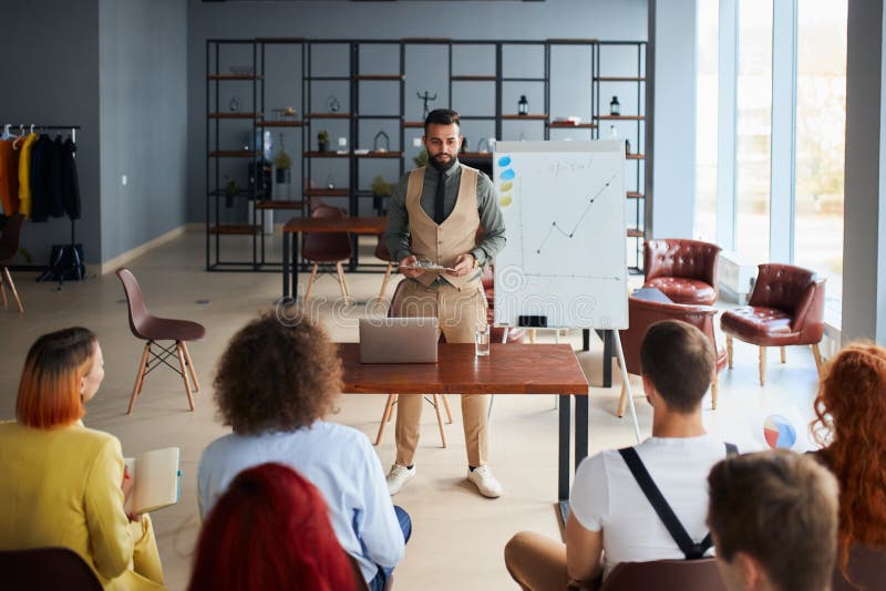 Experienced Young Business Coach Giving Presentation To Executive ... Experienced Young Business Coach Giving Presentation To Executive ...