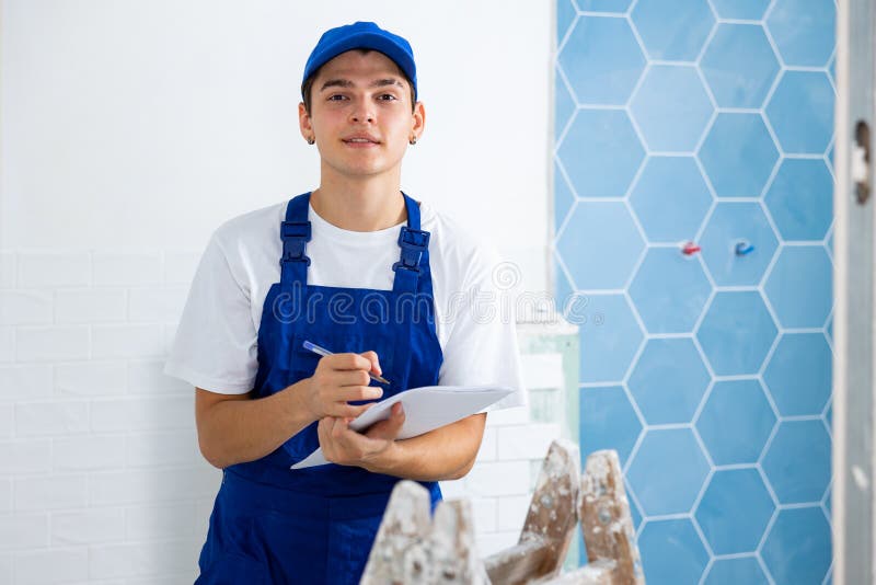 Young Foreman Making Task List during Works in Building Under ...