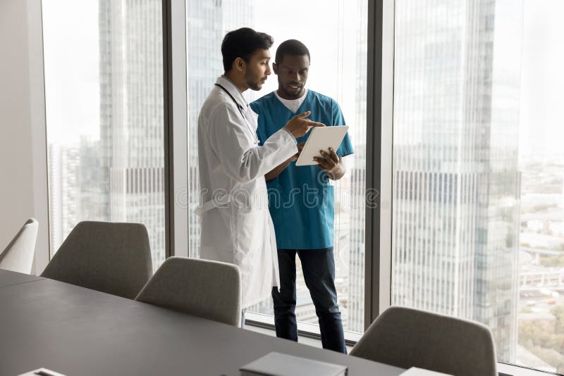 Attending Physician Instruct Nurse at Modern Clinic Office Using Pad ...