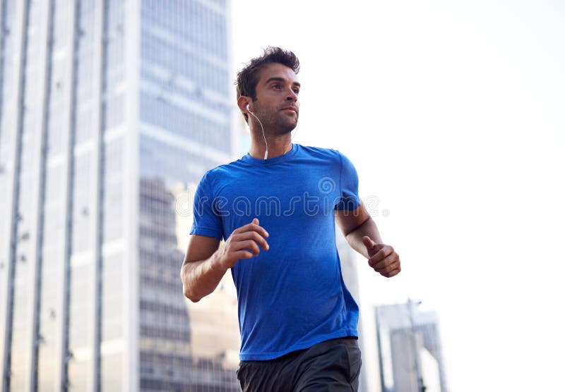 Experiencing the City Life on His Run. a Young Man Jogging through the ...