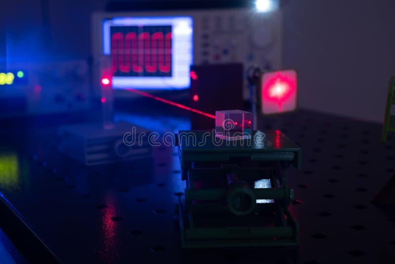 Experiment in Optic Lab with Laser Device. Red Laser on Optical Table ...