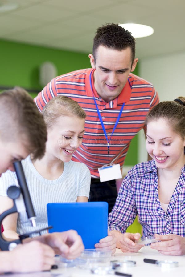 Experimenting with Microscopes in a Science Lesson Stock Photo - Image ...