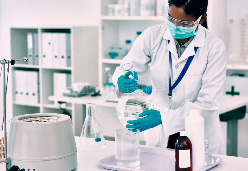 Experimenting To Find a Solution. an Attractive Young Female Scientist ...