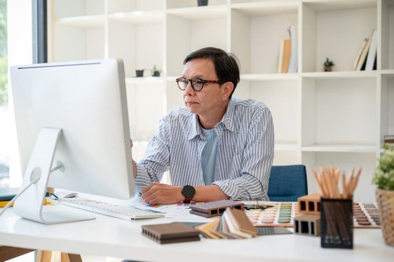An Expert Asian Senior Male Interior Designer is Focused on Checking ...
