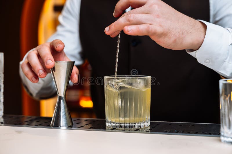 Expert Bartender Preparing a Cocktail with Precise Measurements at a ...