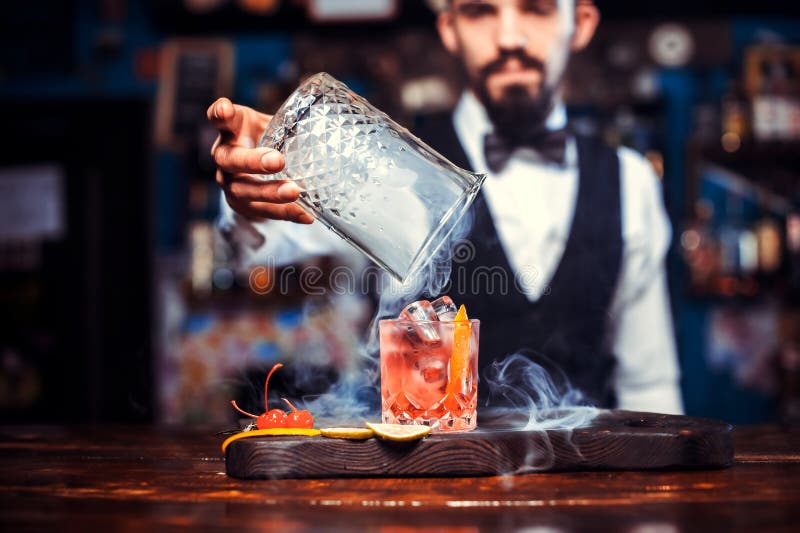 Focused Bartender Demonstrates the Process of Making a Cocktail Stock ...