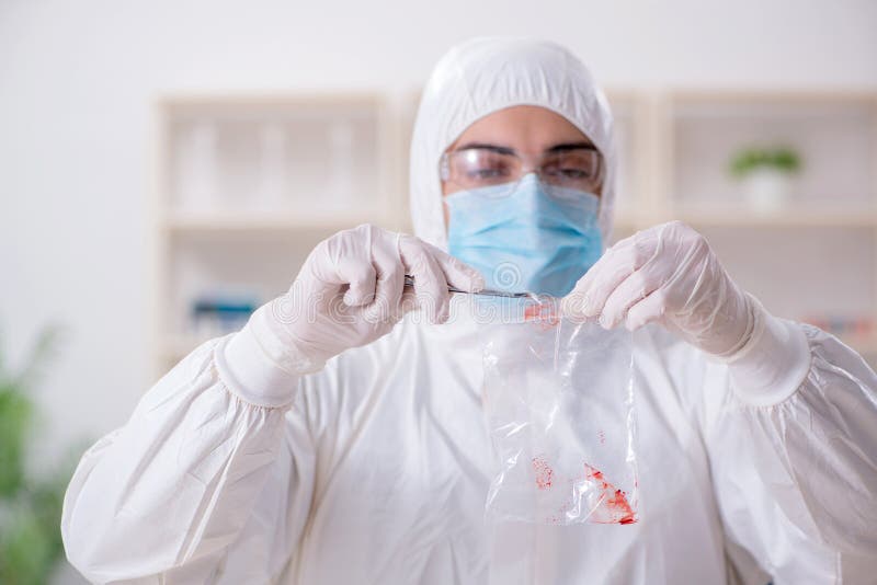 The Expert Criminologist Working in the Lab for Evidence Stock Photo ...