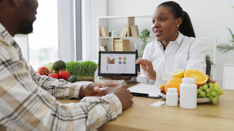 Expert in Diet Displaying Client S Data on Tablet Via Graphs Stock ...
