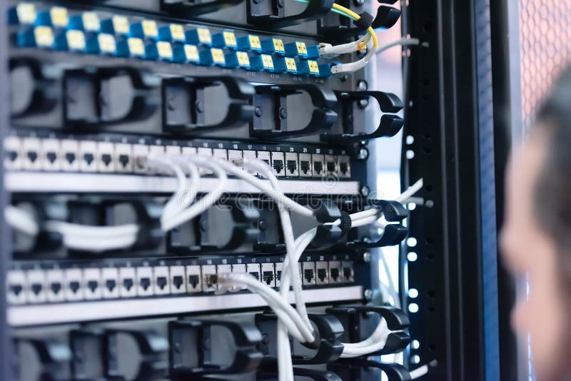 An Expert Engeneer in Datacenter Server Room Connecting Cables in ...