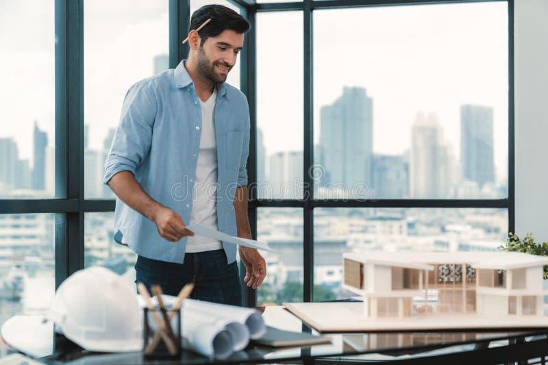 Expert Engineer Holding Blueprint while Comparing with House Model ...