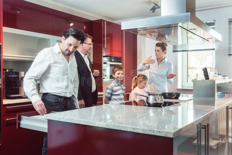 Expert Explaining New Kitchen To Family Looking for One Stock Image ...