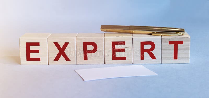Expert Word Written on Wooden Blocks on Blue Table with Pen Stock Photo ...