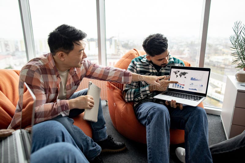 Experts Talking about Data on Computer in Office Interior Stock Image ...