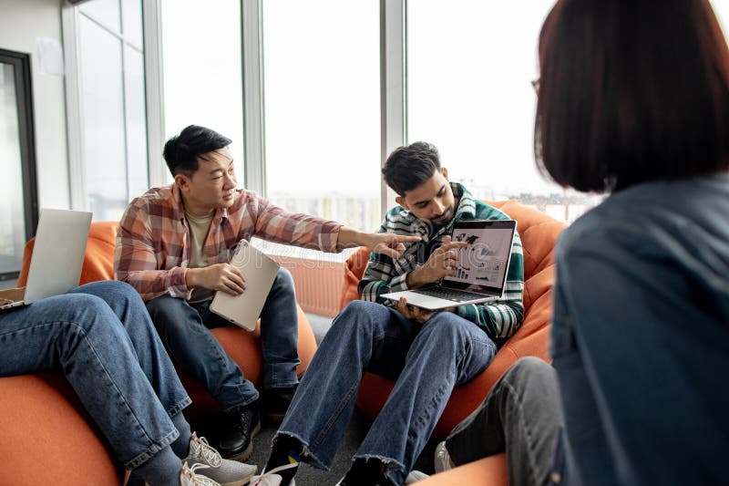 Experts Talking about Data on Computer in Office Interior Stock Image ...
