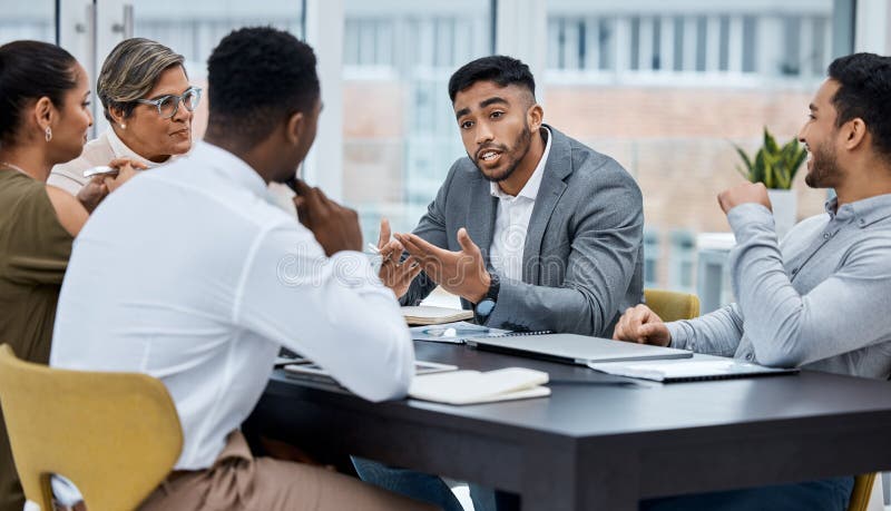 Explaining the Big Idea he Has. a Group of Businesspeople Having a ...