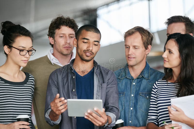 Explaining His Digital Plan. a Group of Coworkers Using a Digital ...