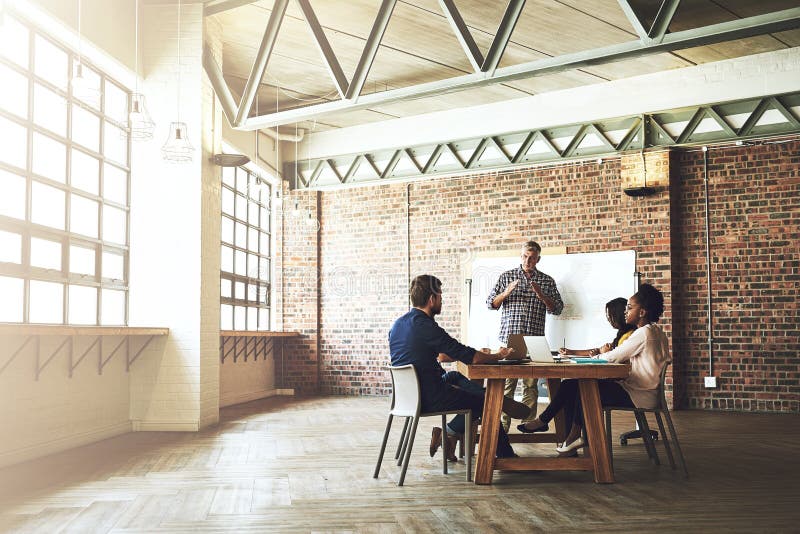 Explaining His Ideas. a Group of Colleagues Having an Office Meeting ...