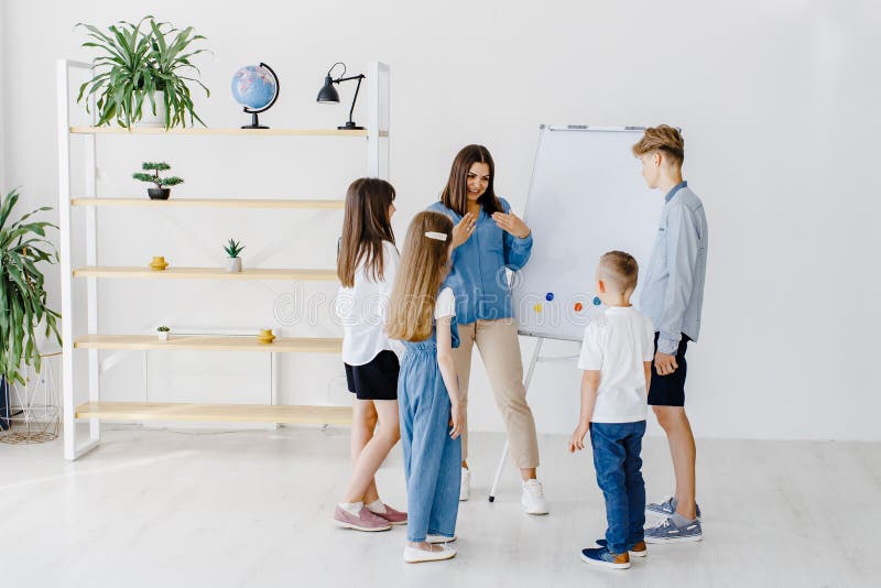 Explaining Lesson and Using Board. Group of Children Students of ...