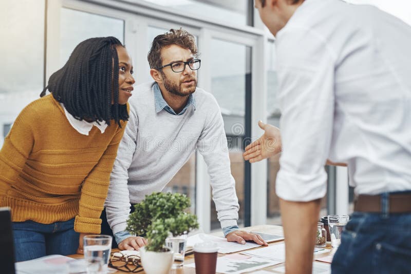 Explaining Their Roles. a Group of Businesspeople Having a ...