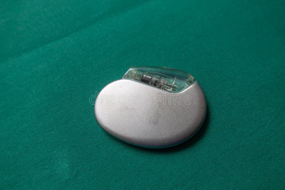 Explanted Pacemaker on a Green Surgical Drape Stock Image - Image of ...