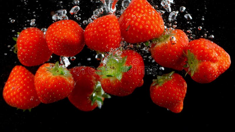 Exploding Strawberries with Water on a Black Background. Stock Video ...