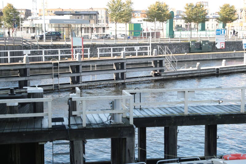 Modern Waterfront Dock with Urban Background and Calm Waters Stock ...