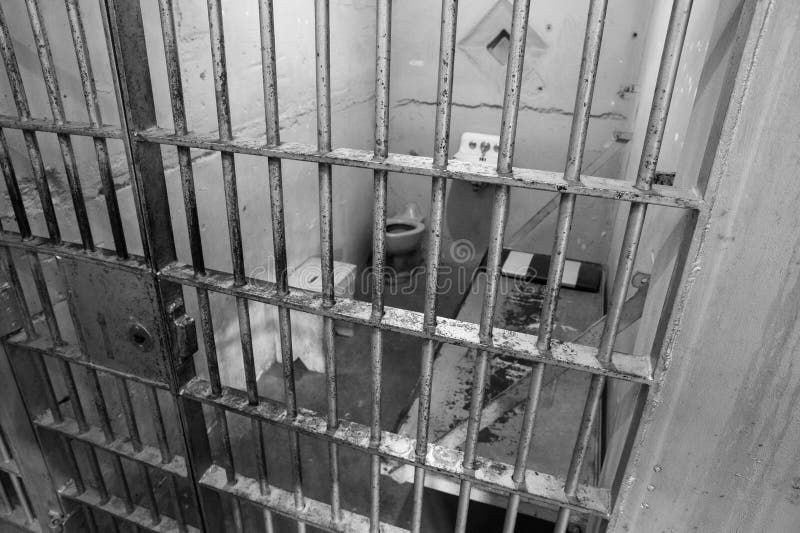 Desolate Prison Cell Interior Captured in Black and White Stock Photo ...