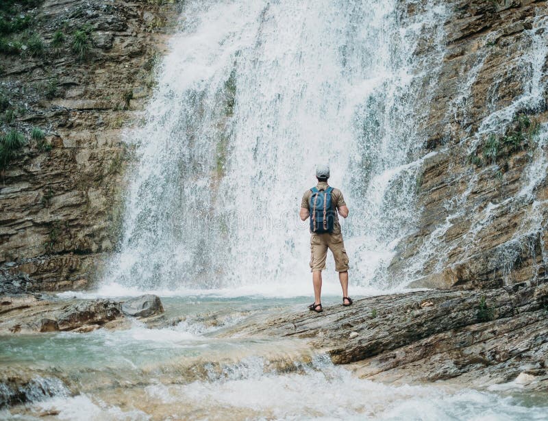 Explorer man and waterfall stock image. Image of journey - 73765219