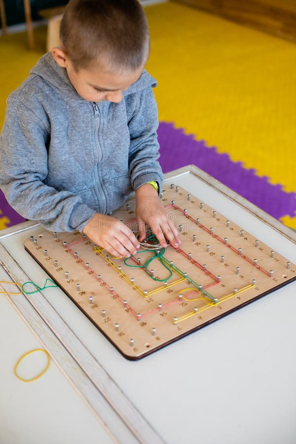 Exploring Basic Math and Geometry Concepts with Geoboard Stock Photo ...