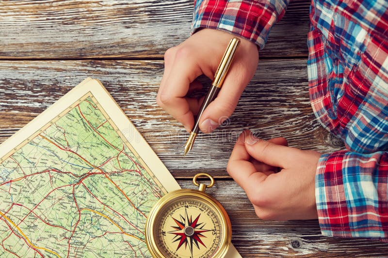 Exploring a Detailed Map with a Compass and Pen on a Wooden Table Stock ...