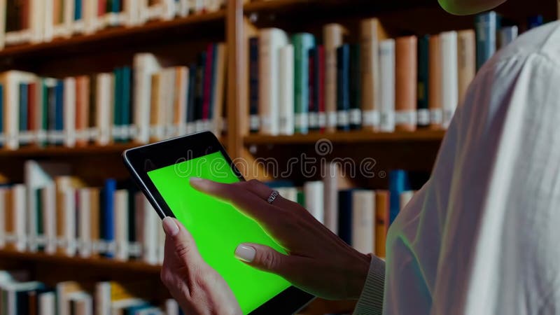 Exploring Digital Technology with a Tablet in a Library Scene Stock ...