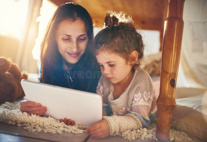 Exploring the Digital World. a Mother and Her Little Daughter Using a ...