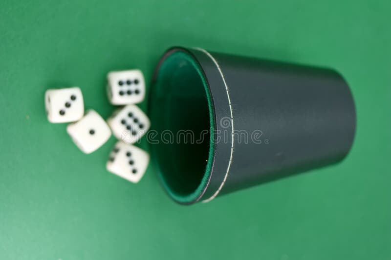 Exploring the Excitement of a Dice Game with a Cup on a Green Su Stock ...