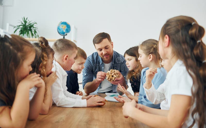 Exploring Puzzle Toy. Group of Children Students in Class at School ...