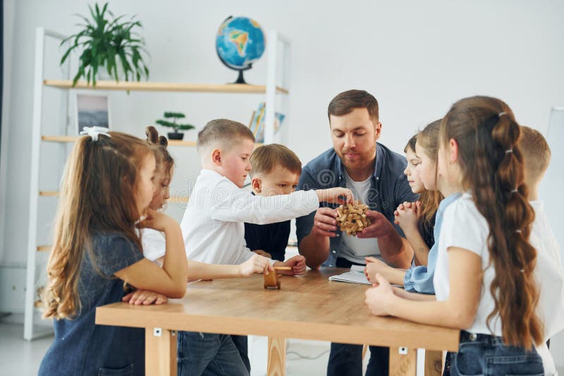 Exploring Puzzle Toy. Group of Children Students in Class at School ...